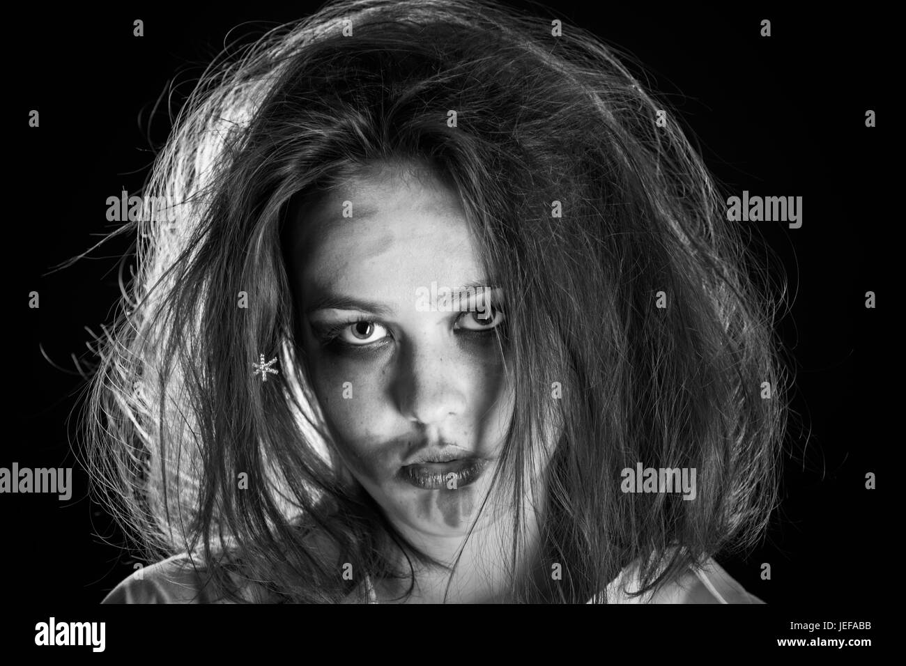 Pretty Fun Crazy Girl With Fluffy Hair And Smeared Cosmetics On Black Background Monochrome