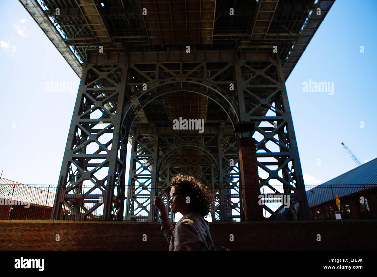 Curly hair woman under Williamsburg Bridge, Brooklyn, NY, USA Stock ...