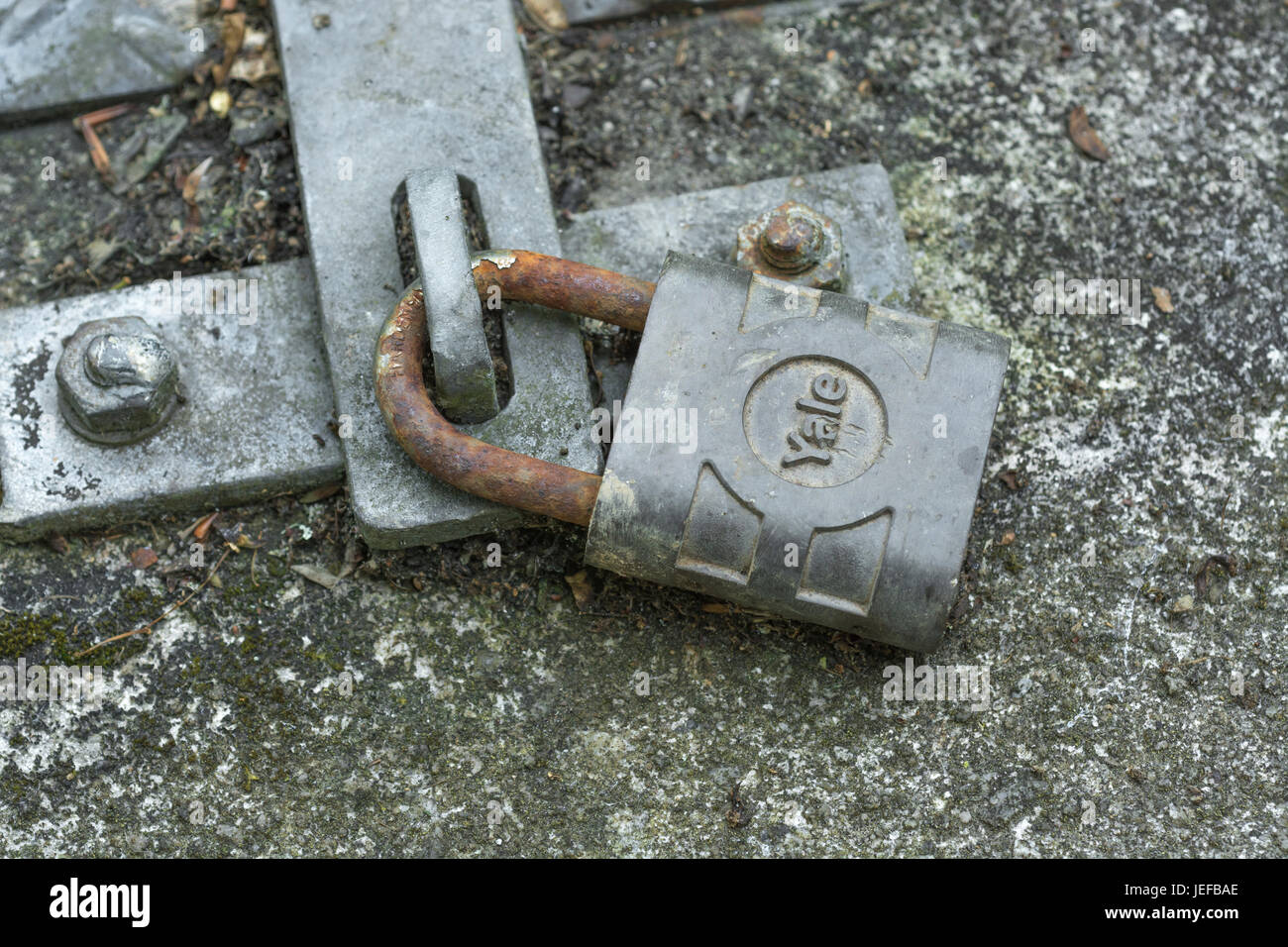 Locked padlock blocking access to manhole cover. Metaphor locked in ...