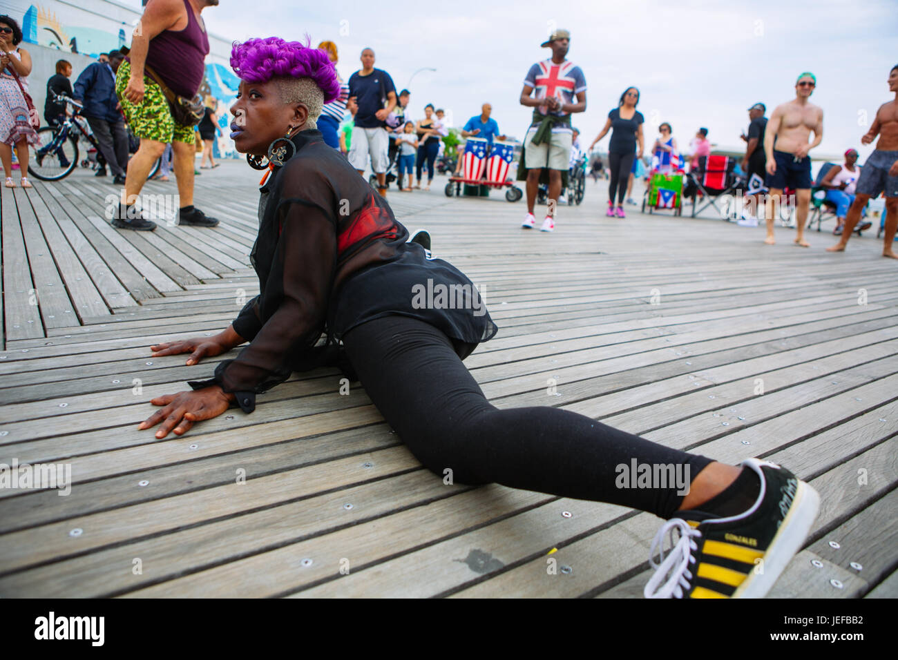Black woman with cool fancy violet hair, break dancing in Coney Island ...