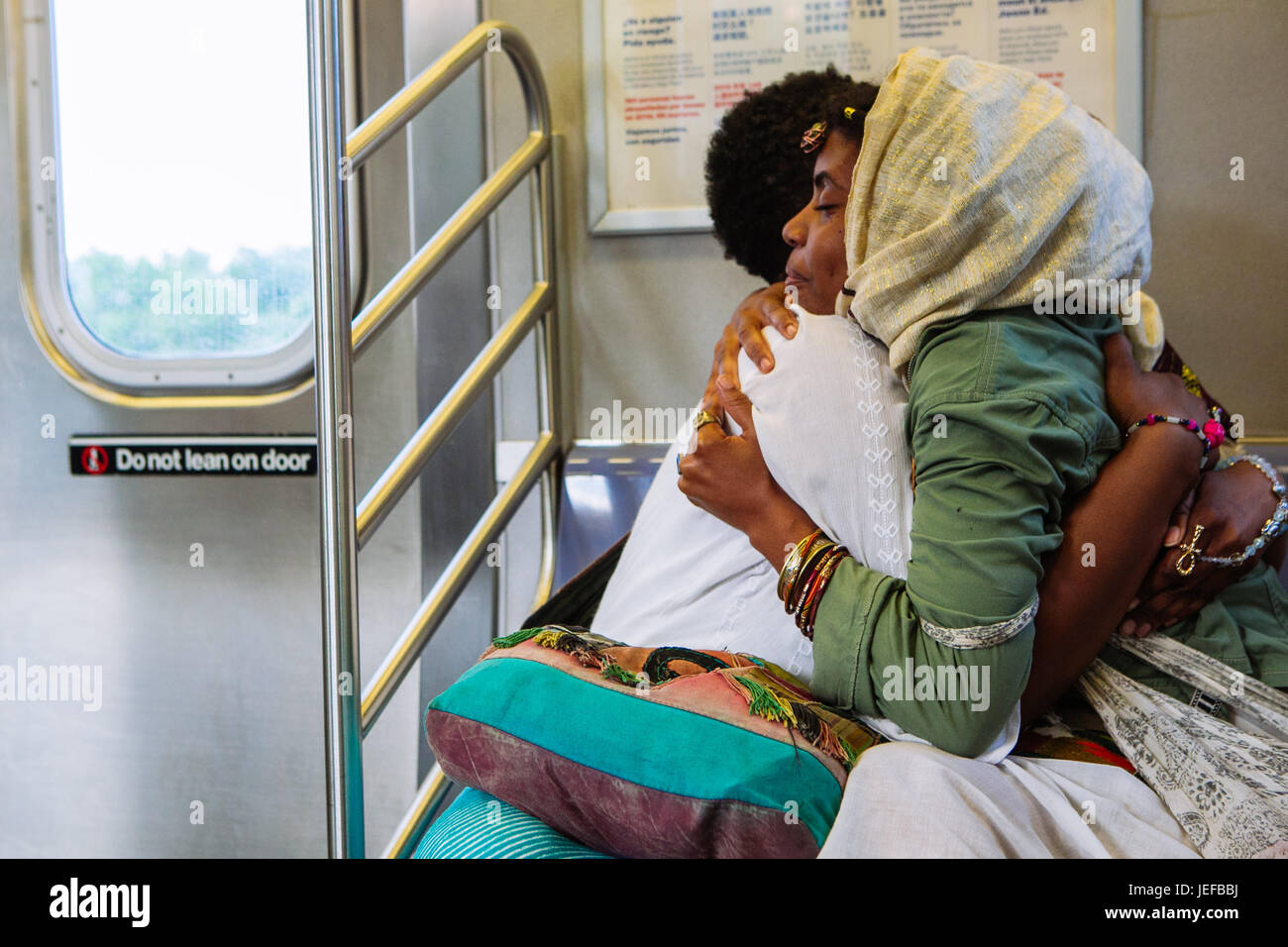 Two black women hugging each other hi-res stock photography and images ...