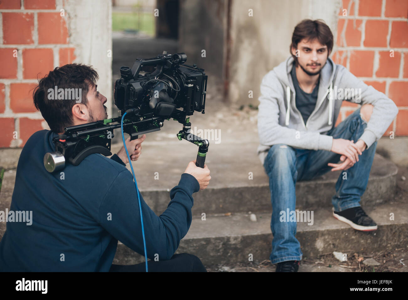 Behind the scene. Actor in front of the camera on the film set outdoor ...