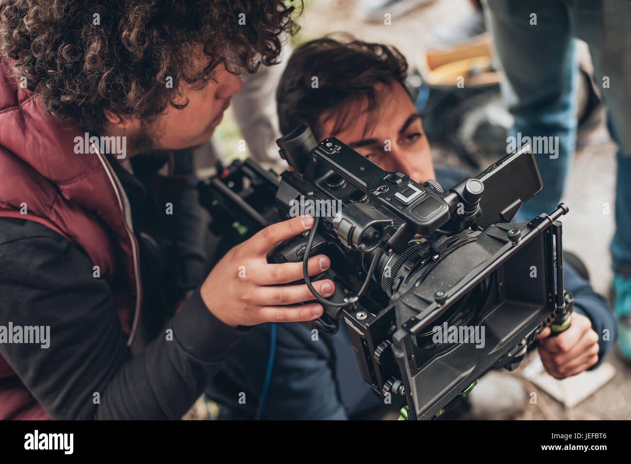 Behind the scene. Cameraman and assistant shooting the film scene with ...