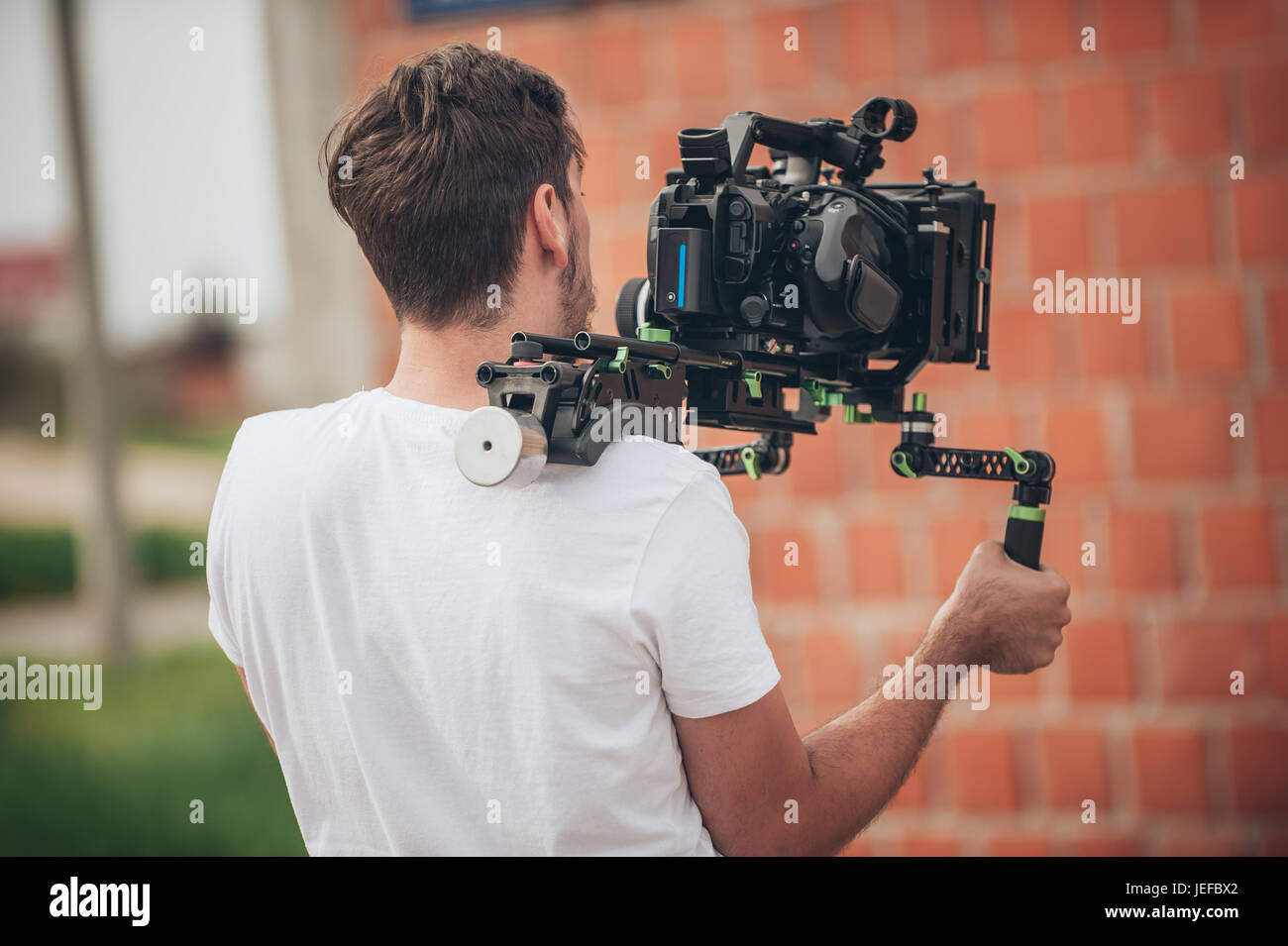 Behind the scene. Cameraman shooting the film scene with his camera on ...