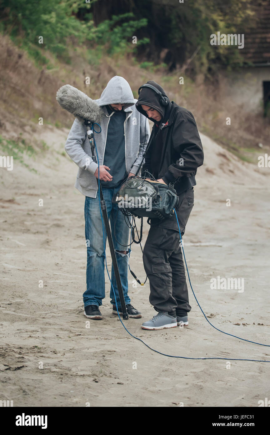 Behind the scene. Sound director and boom microphone operator check ...