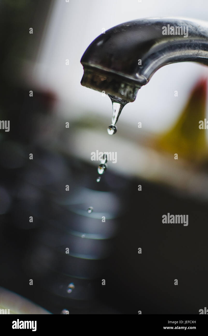 Sink Tap Drip. Plates and washing up in the background Stock Photo - Alamy