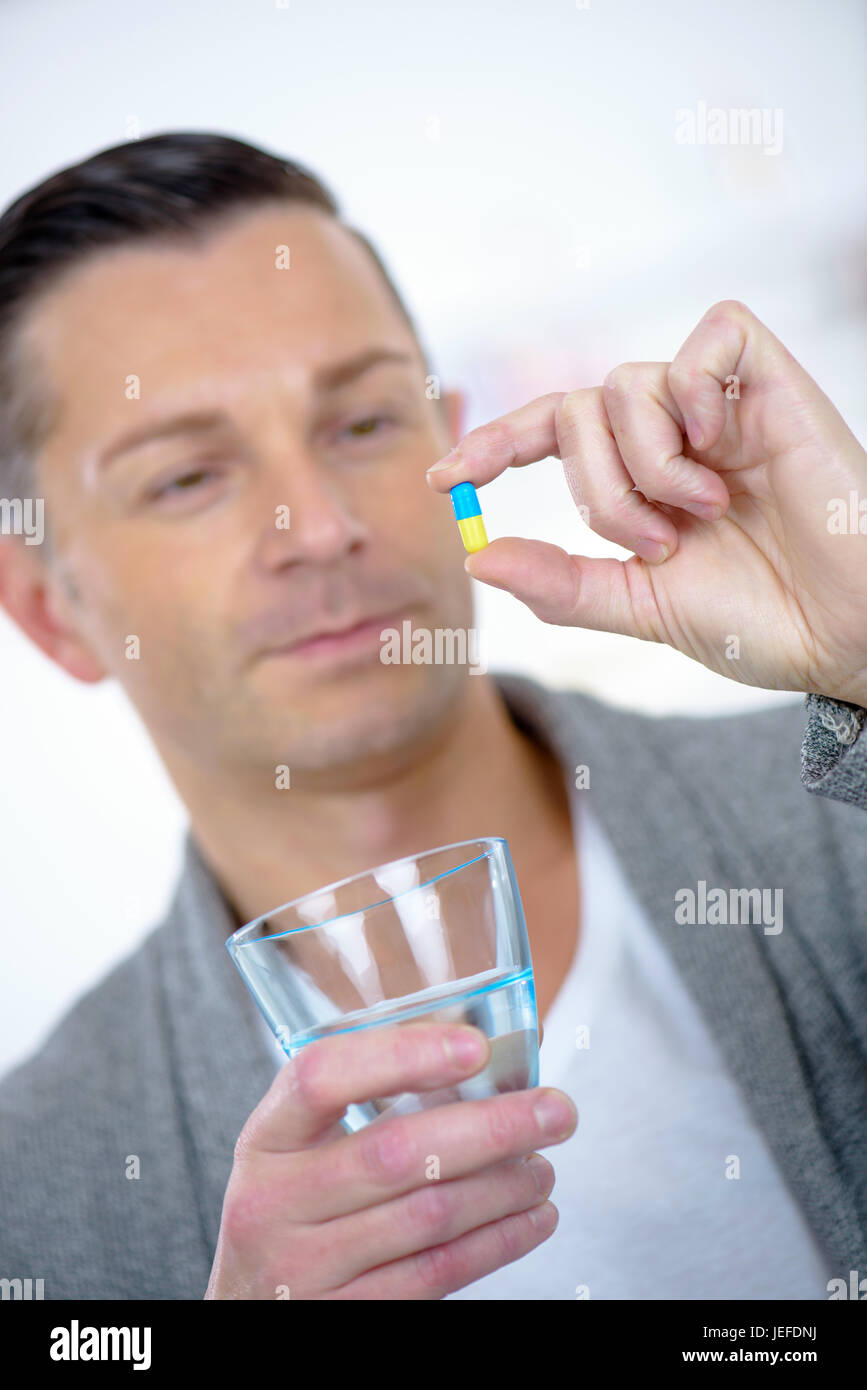 Man holding tablet and glass of water Stock Photo - Alamy
