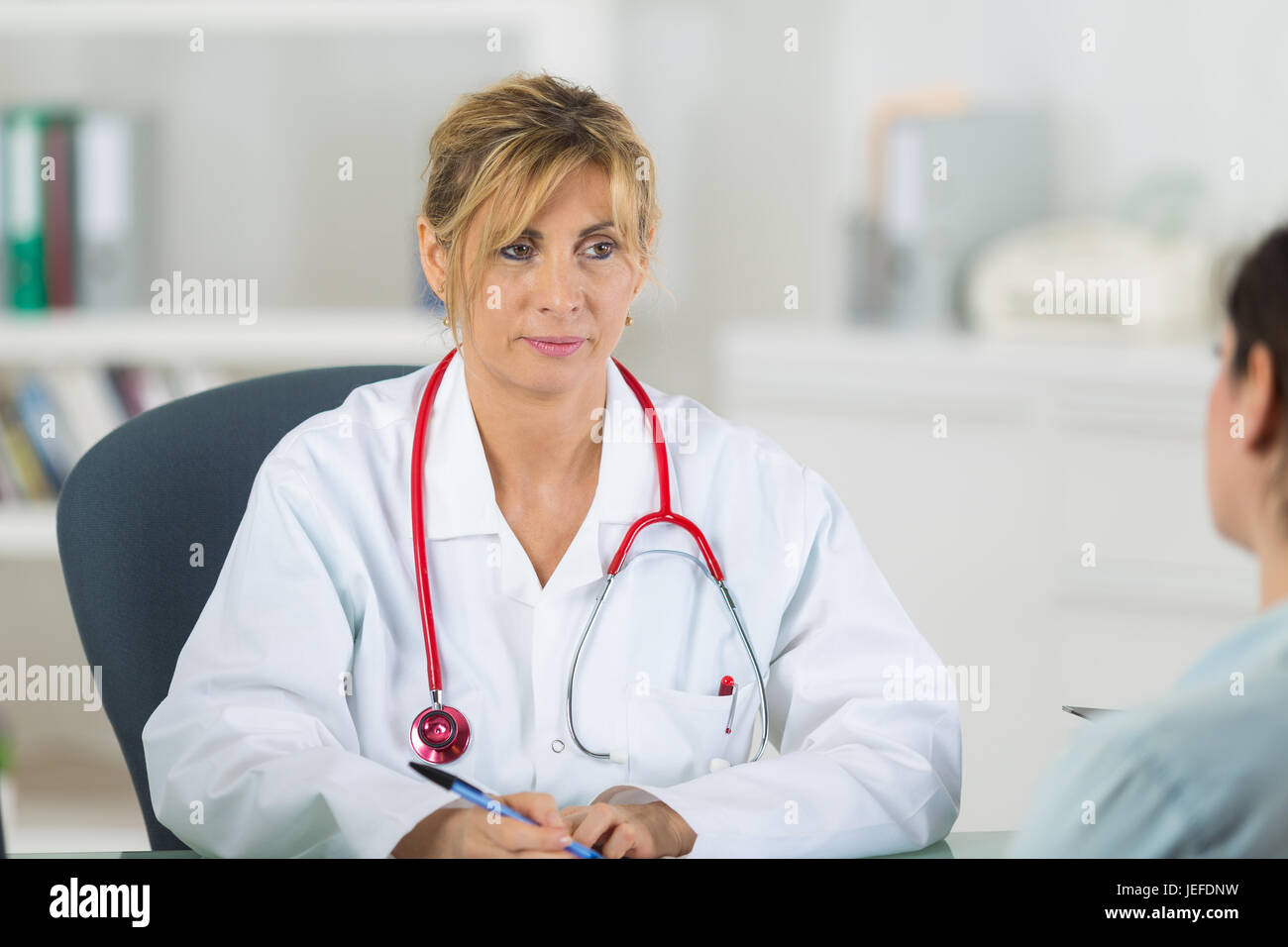 Female doctor tied stethoscope hi-res stock photography and images - Alamy
