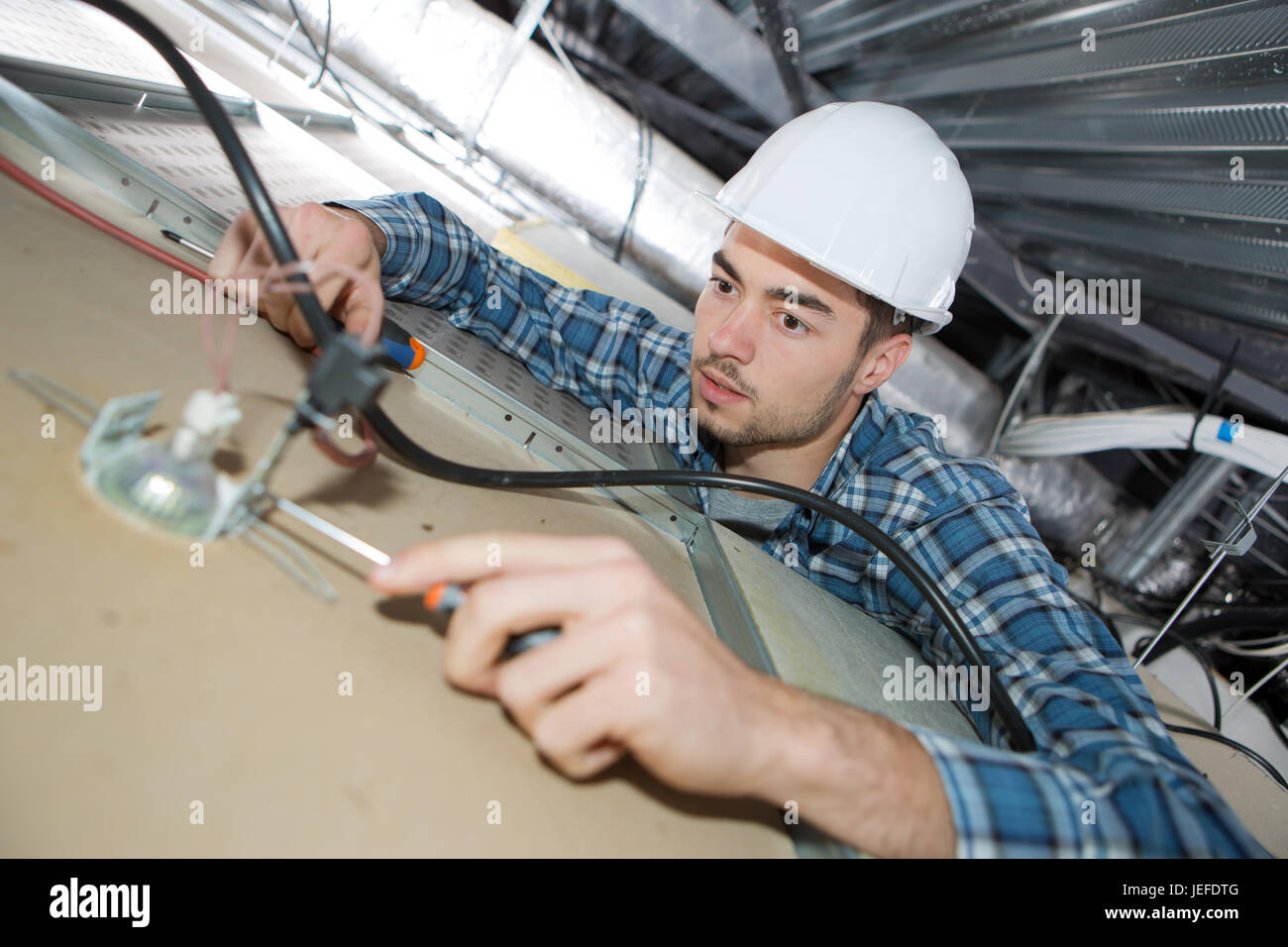 Man ladder fixing cables hi-res stock photography and images - Alamy