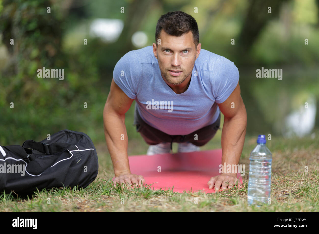 muscular man push ups in a park Stock Photo - Alamy