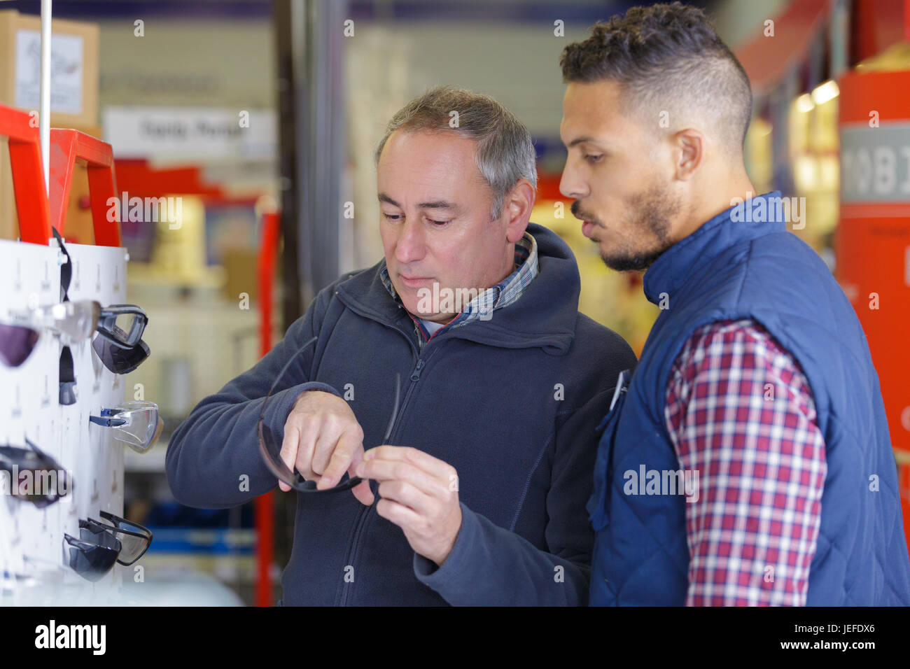 salesman assisting customer in buying product at hardware store Stock ...