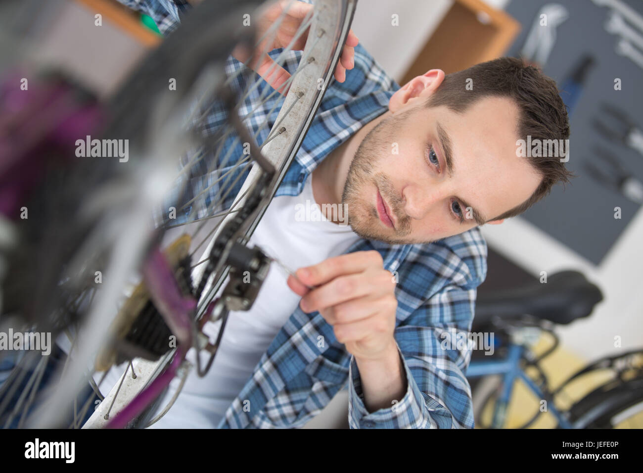 young man repairing bike Stock Photo - Alamy