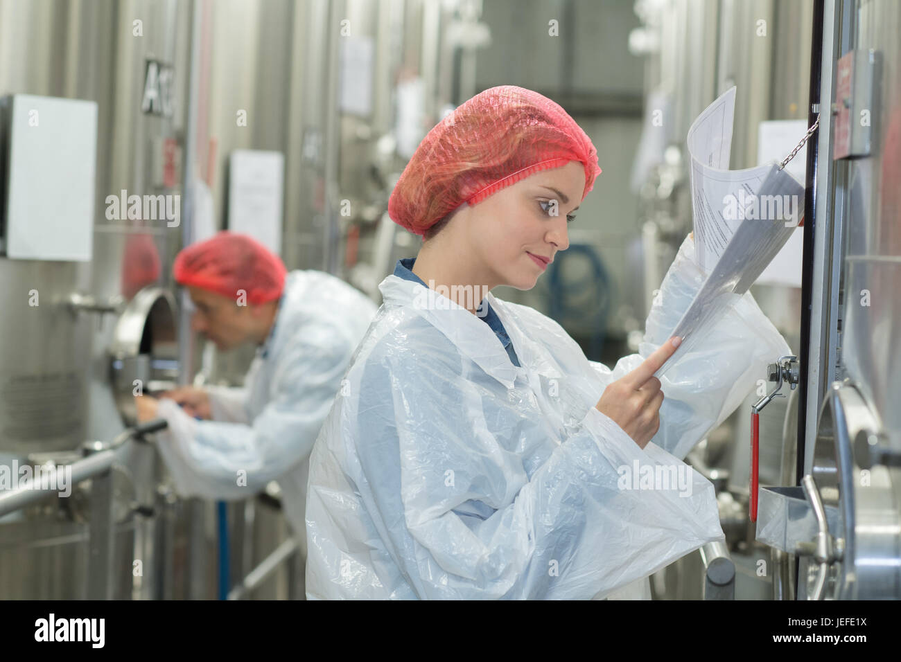 happy scientists posing checking paperwork in factory Stock Photo - Alamy
