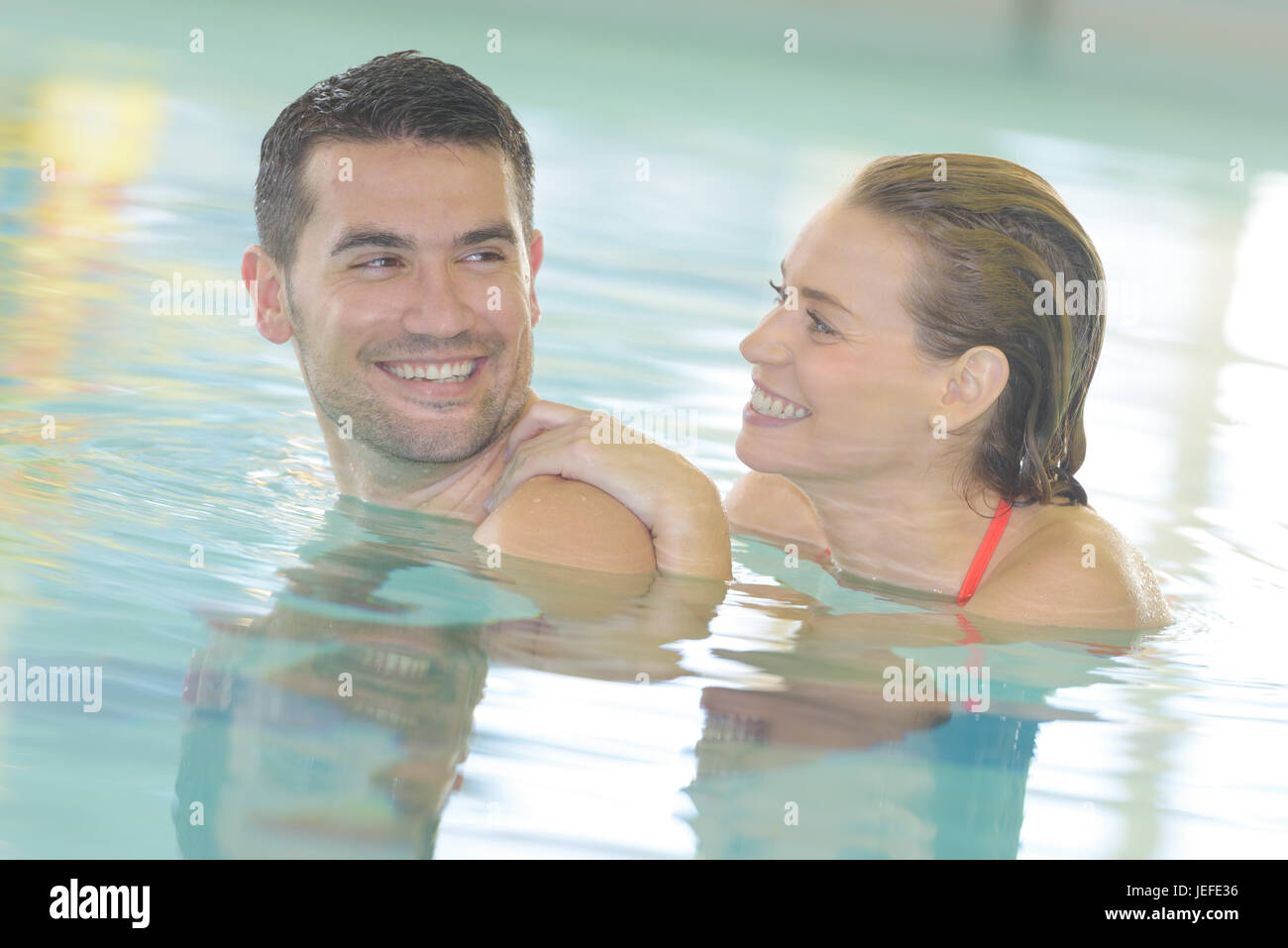 Young women talking in swimming pool hi-res stock photography and ...