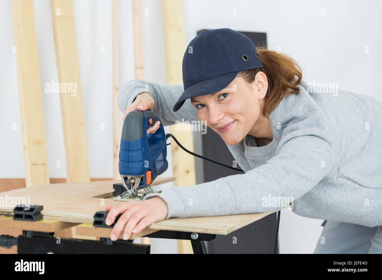 Woman using electric saw hi-res stock photography and images - Alamy