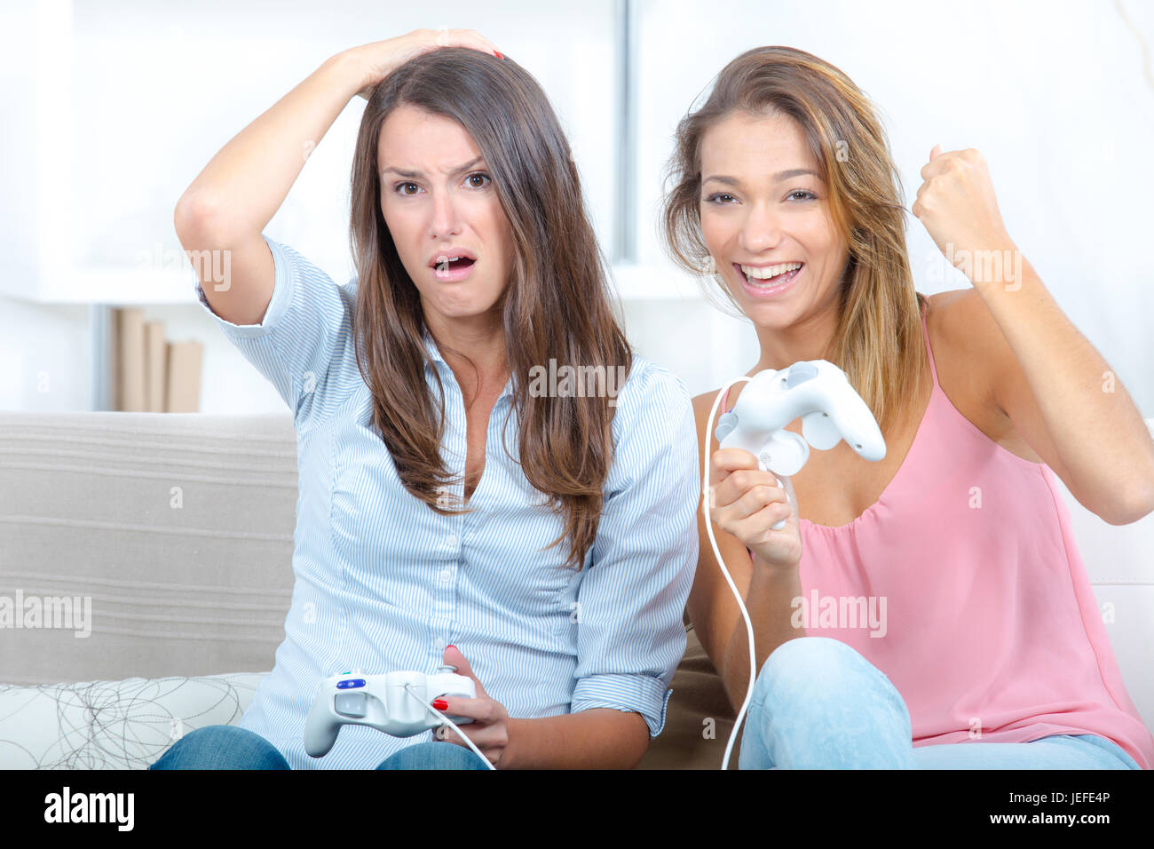 two girls play video games Stock Photo - Alamy