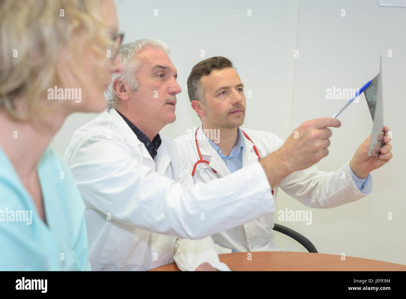 Doctors checking medical report hi-res stock photography and images - Alamy