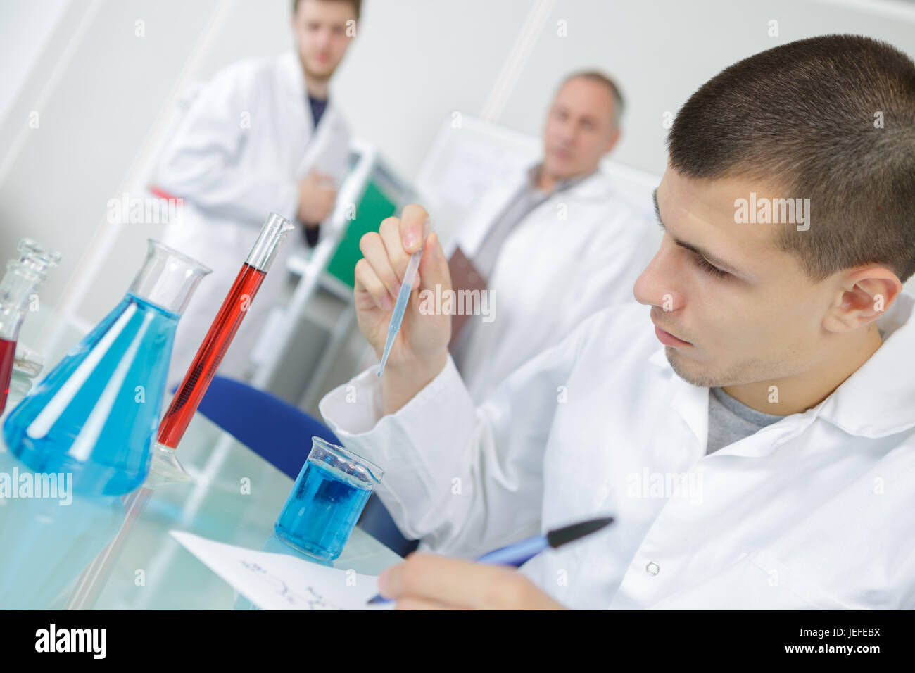 young scientist mixing chemical liquid for his experiment Stock Photo ...