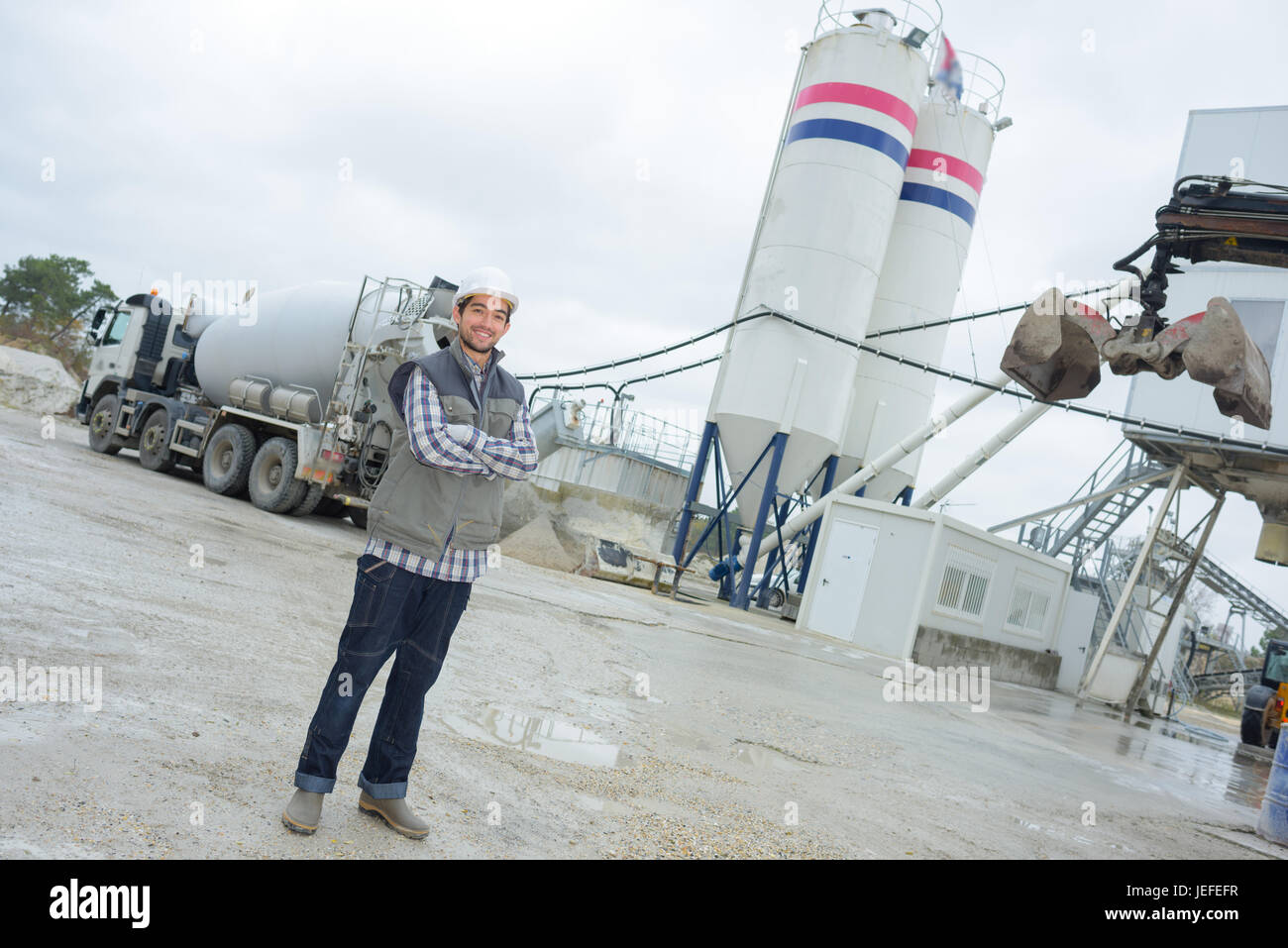 laborer outside a factory working dressed with safety overalls ...