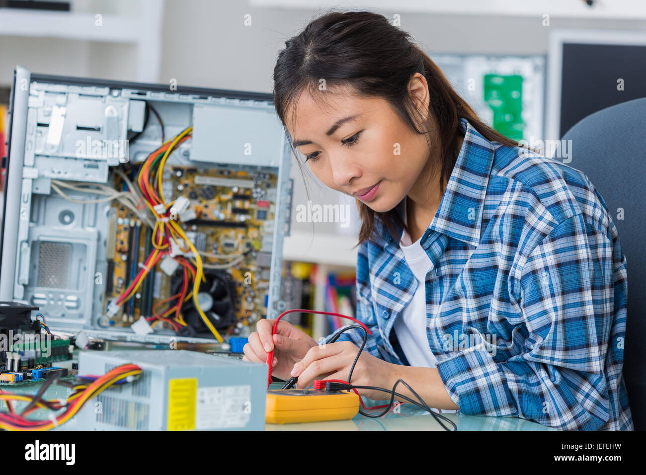Asian woman repairing computer Stock Photo - Alamy