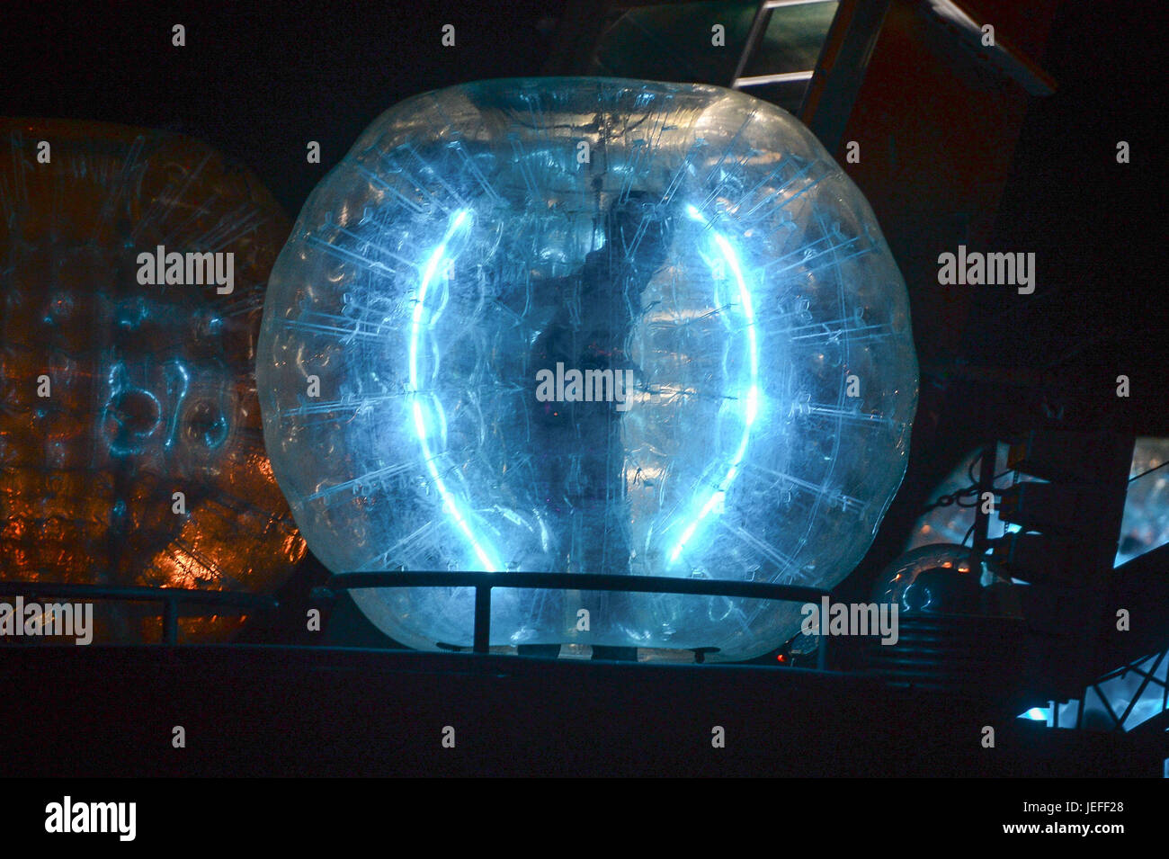 A person inside a glowing orb moves as part of the metamorphosis show ...