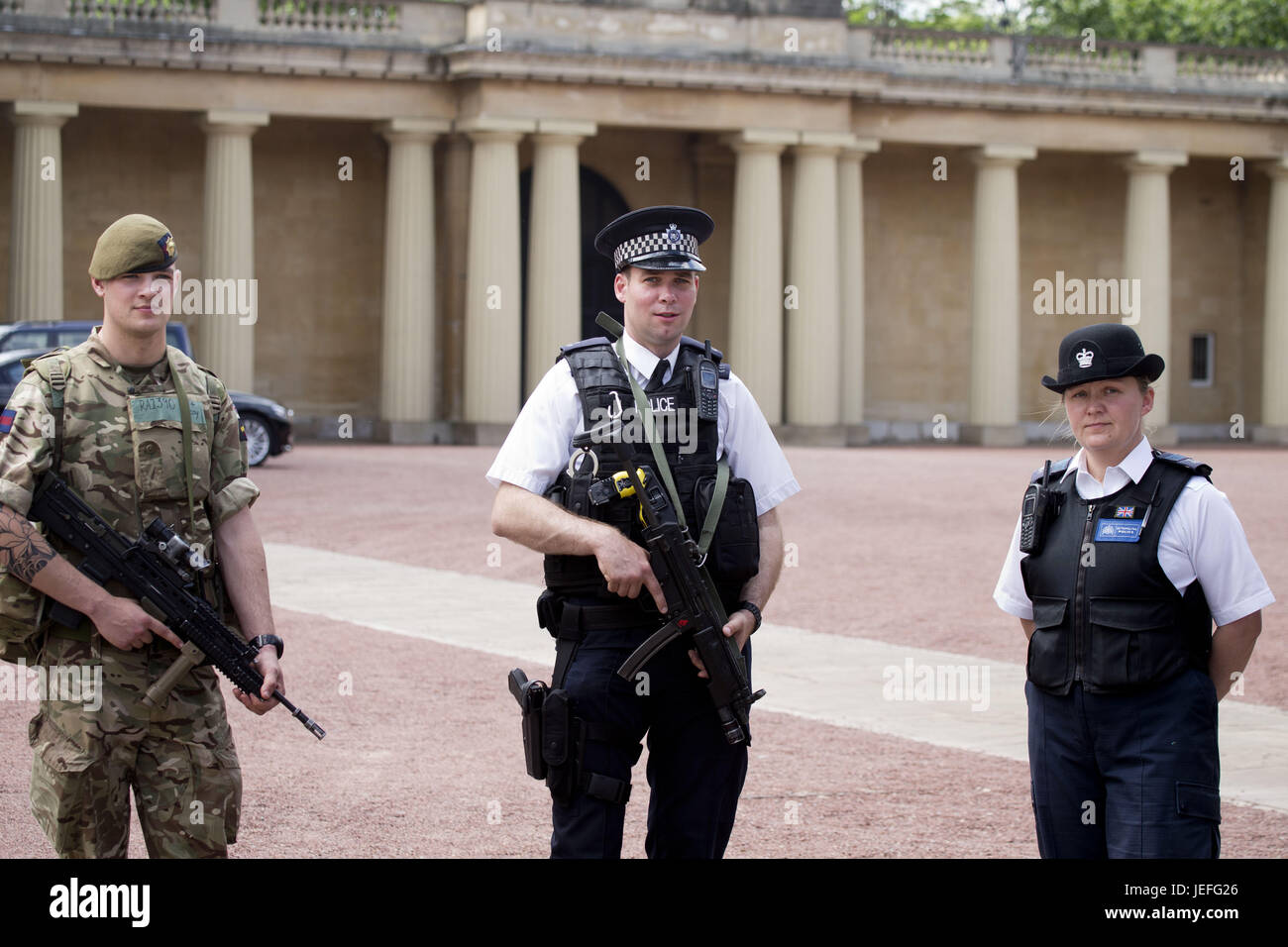 Armed police and military protecting Buckingham Palace. Featuring ...