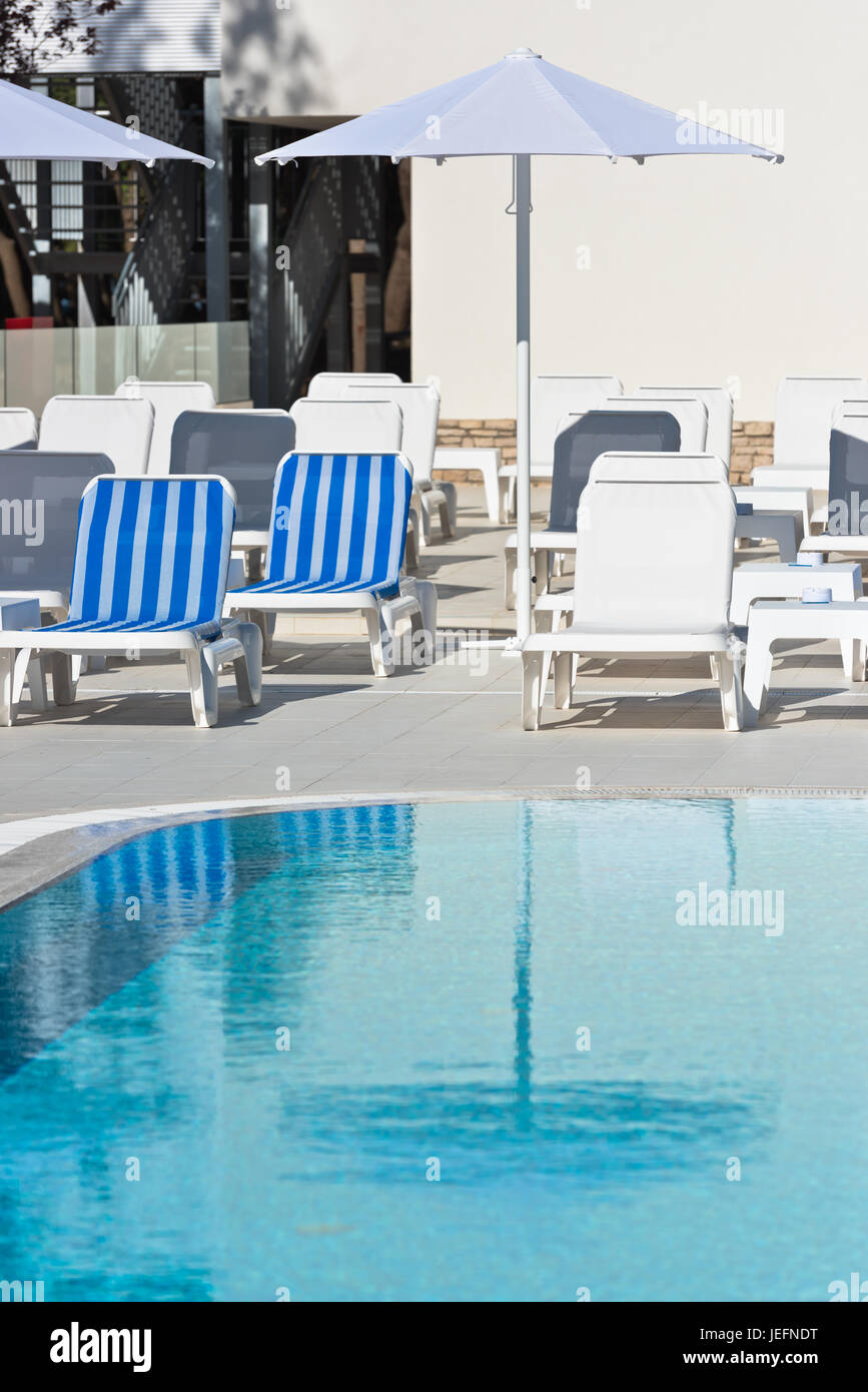 sunbeds and umbrellas by the swimming pool on a sunny day Stock Photo ...