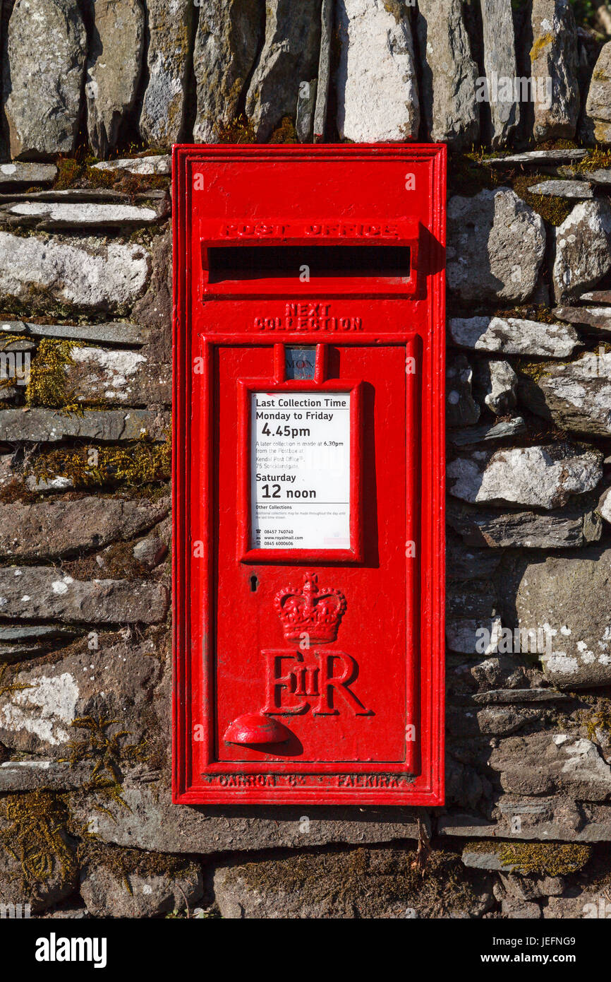 Red Letterbox. A traditional red English letterbox mounted in a dry ...