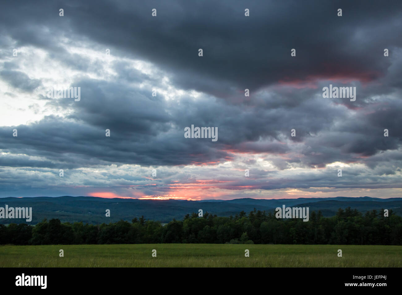 Dramatic Red Sunset Over Mountains Stock Photo - Alamy