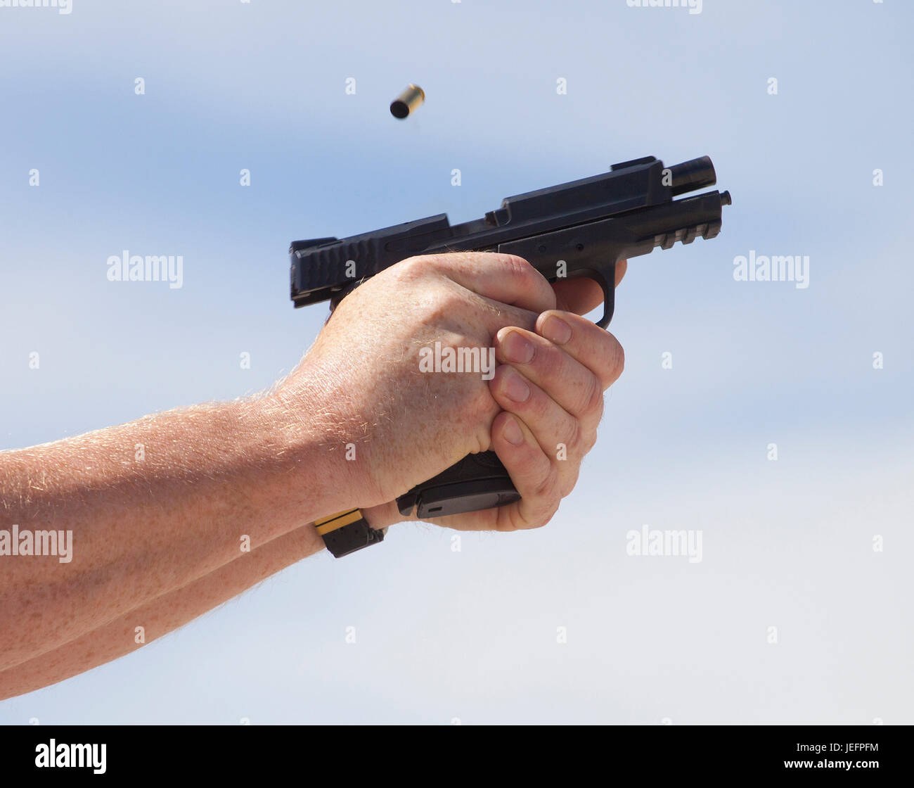 Handgun with brass ejecting just after being shot Stock Photo - Alamy