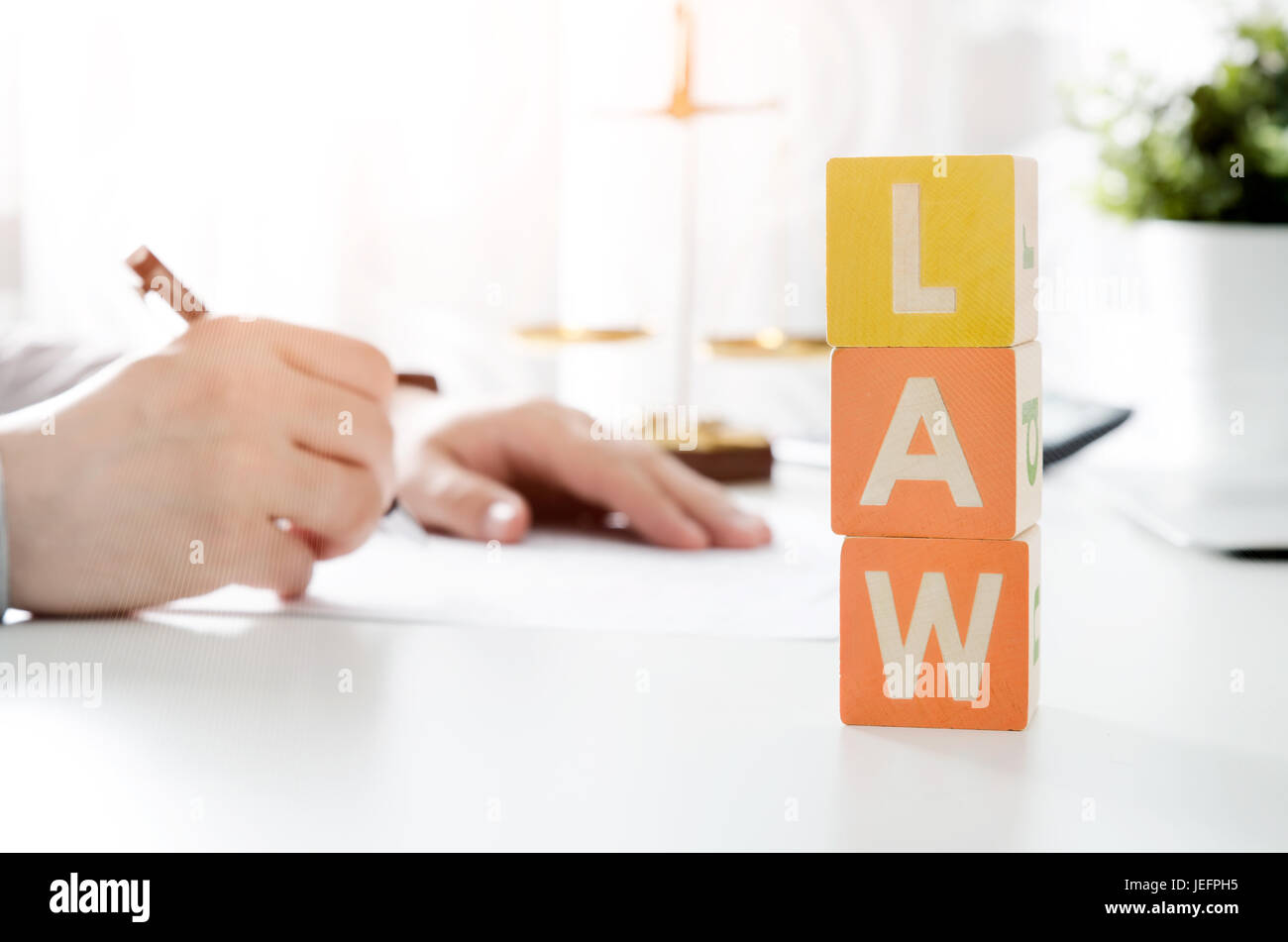 LAW word from toy blocks. Lawyer working in background. lawyer law ...
