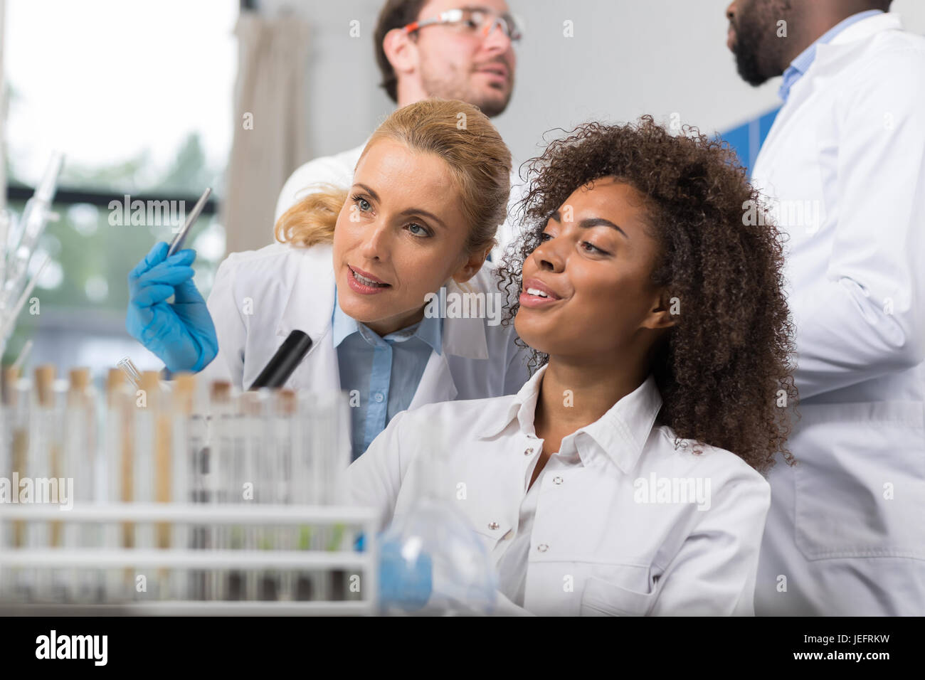 Two Female Scientist Examine Sample Working In Modern Laboratory, Group ...
