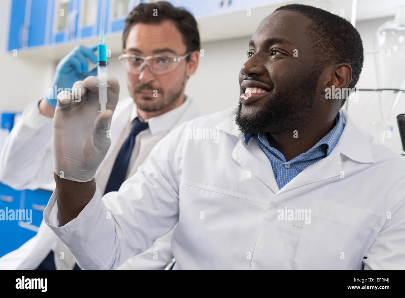 Two Male Laboratory Scientists Examining Samples Injection In Syringe ...