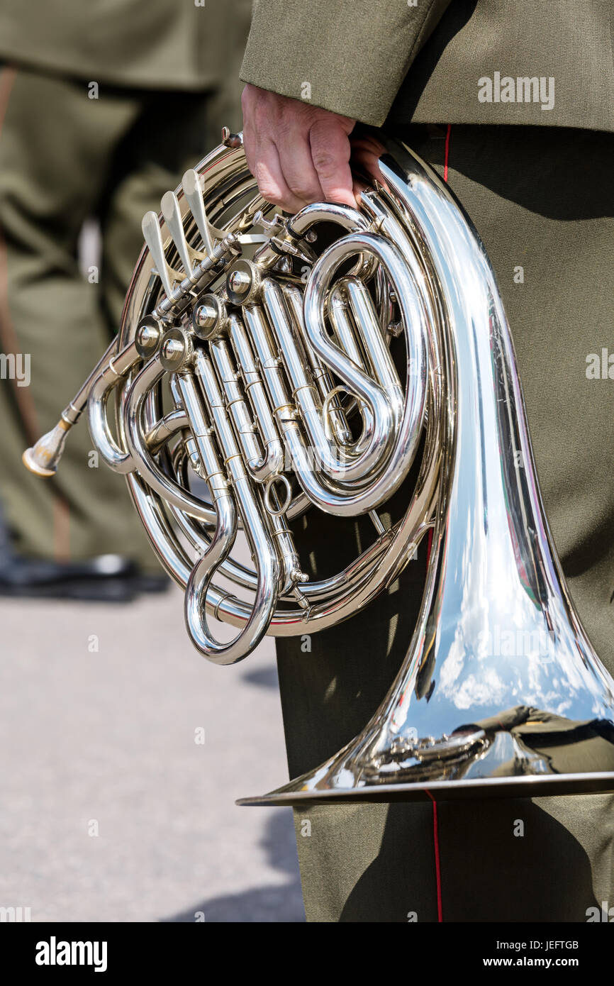musician of a military orchestra holding horn in his hand during ...