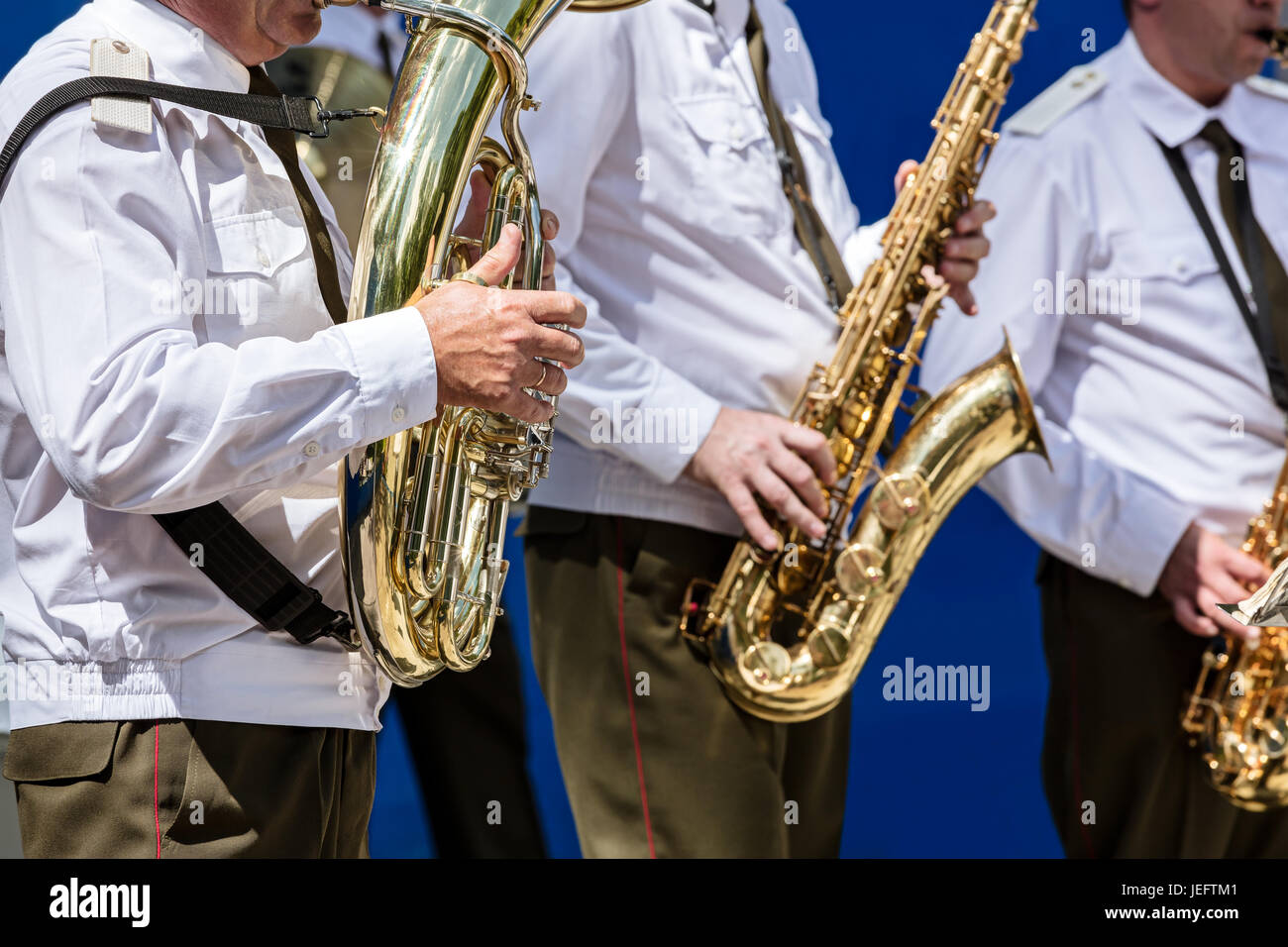 military brass band musicians in uniform playing during outdoor concert ...