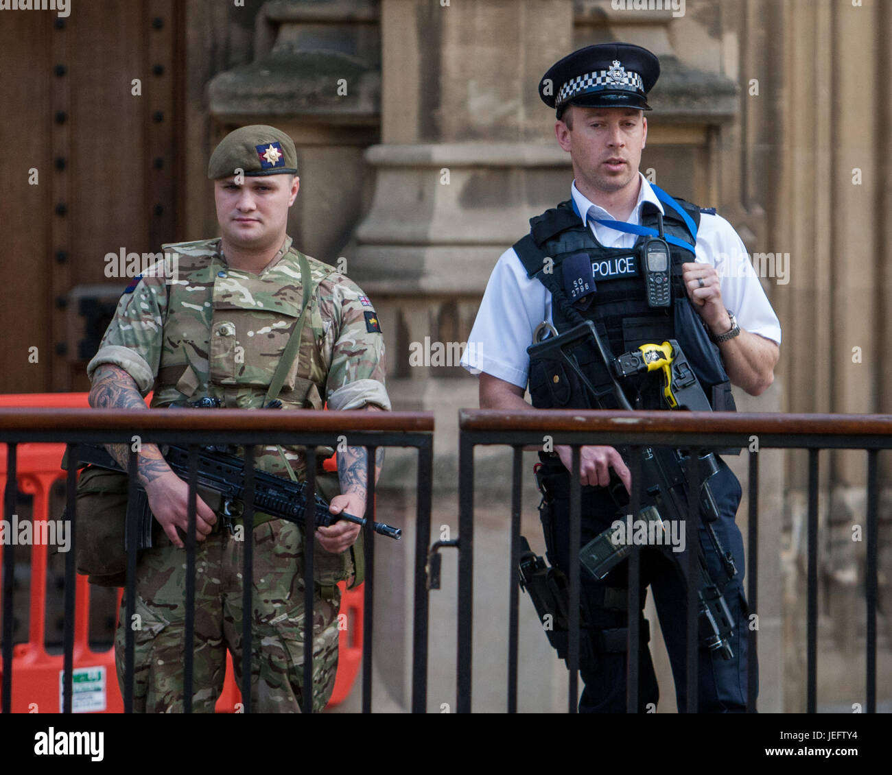Army personnel on guard with Metropolitan police officers at the Palace ...