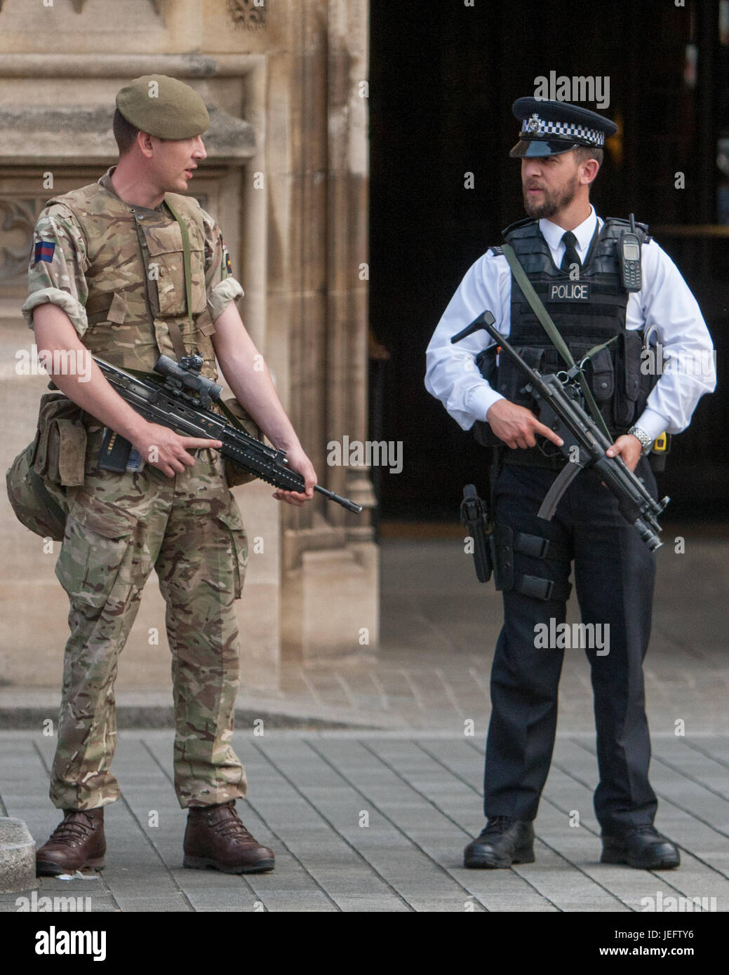 Army personnel on guard with Metropolitan police officers at the Palace ...