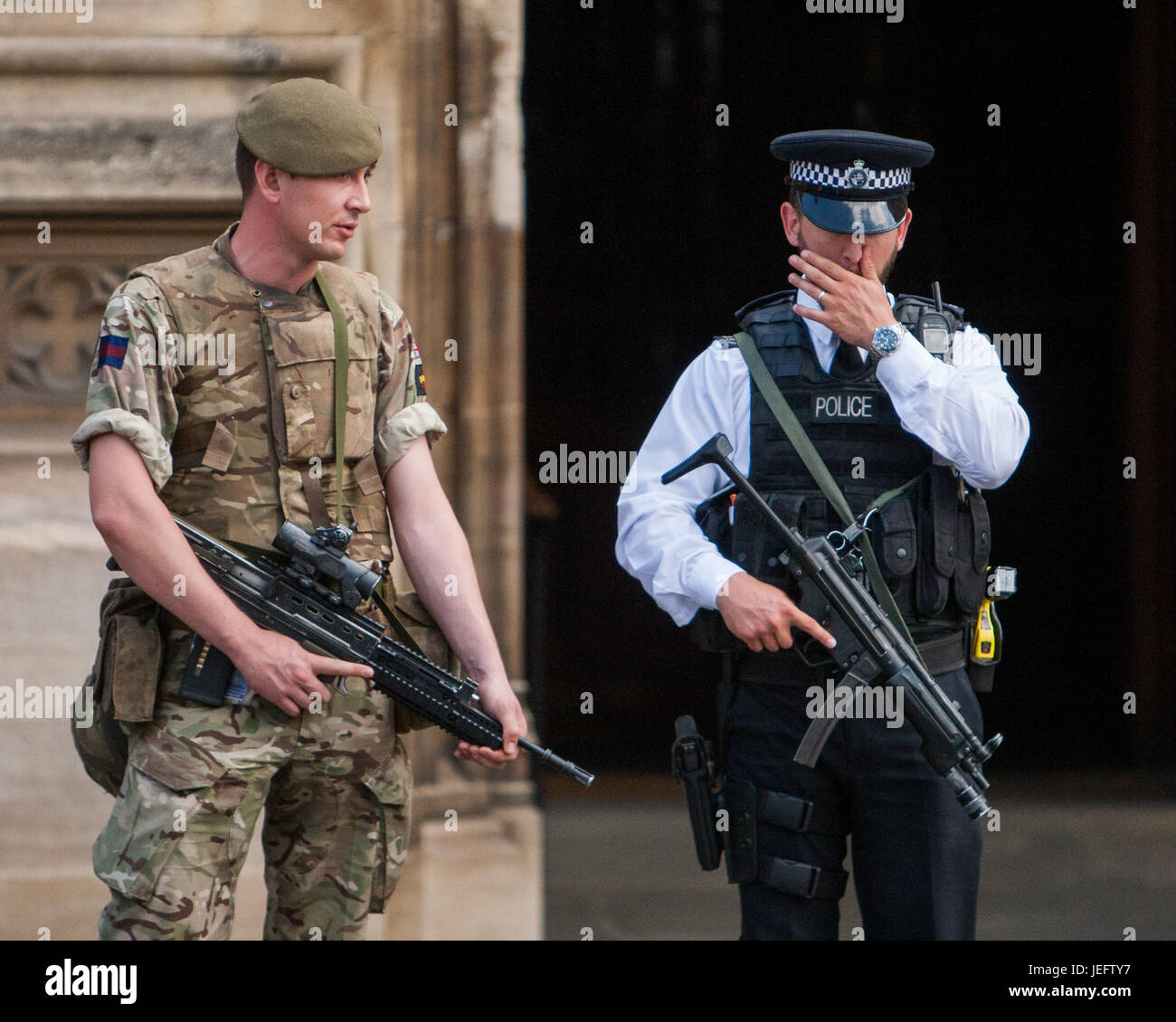 Army personnel on guard with Metropolitan police officers at the Palace ...