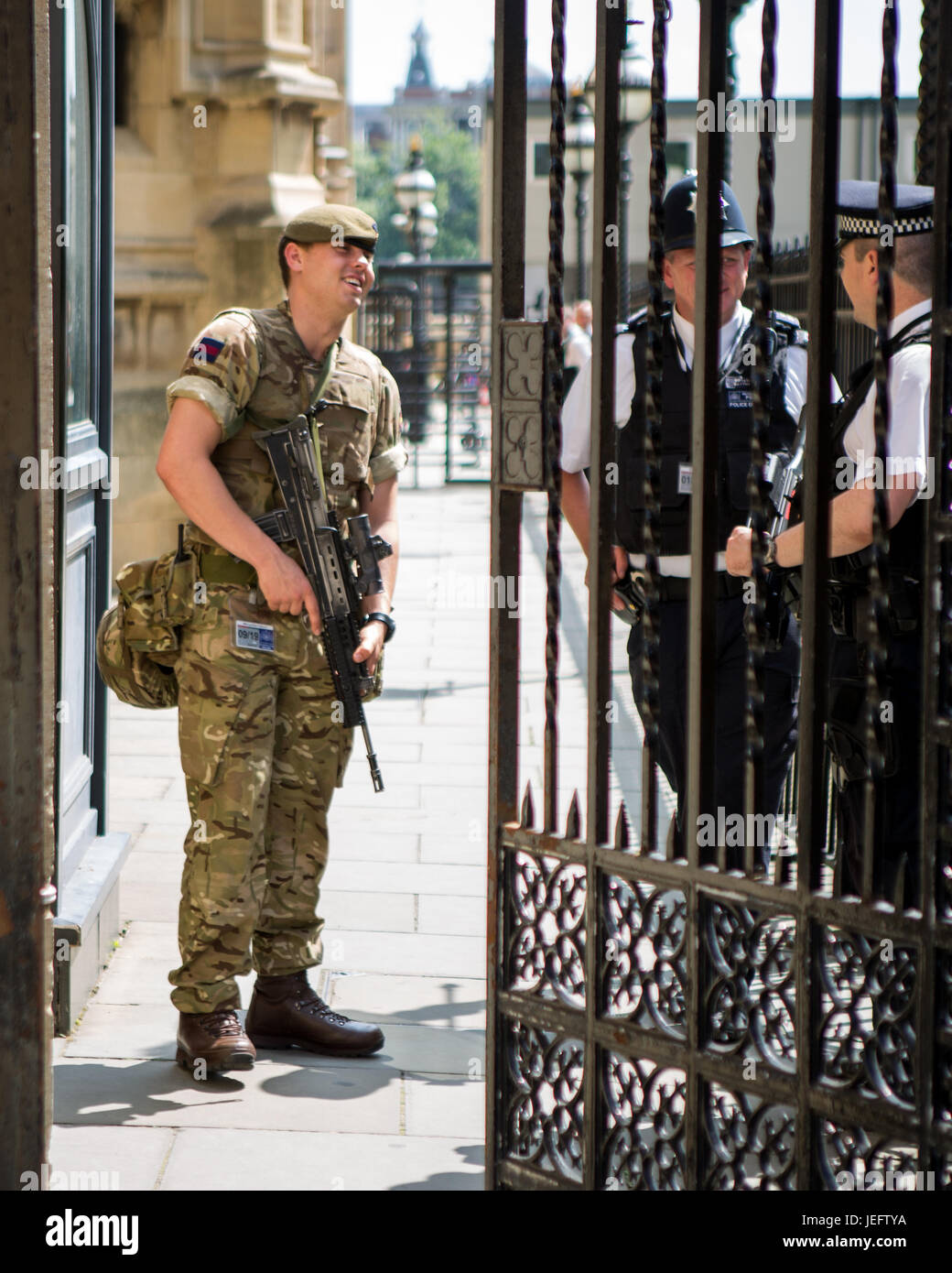 Army personnel on guard with Metropolitan police officers at the Palace ...