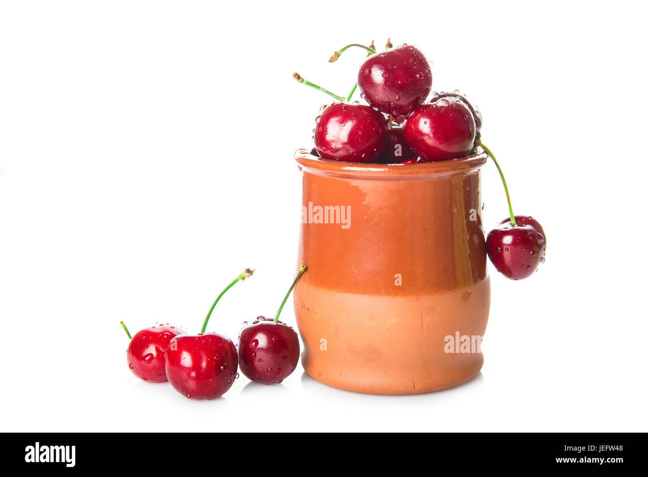 Clay pot with fresh cherries isolated on a white background Stock Photo ...
