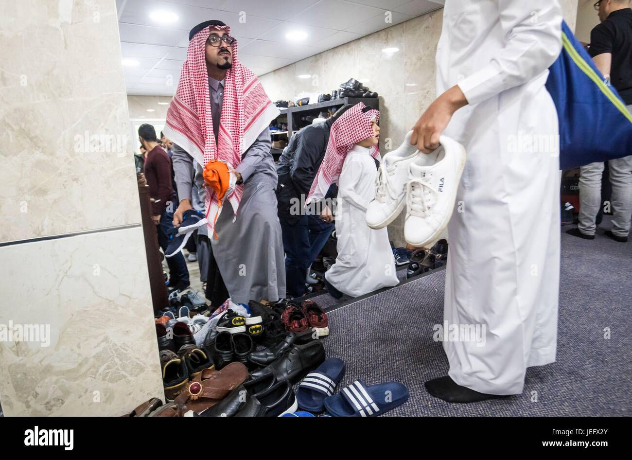 Worshippers remove their shoes as they arrive ahead of the Eid prayer ...