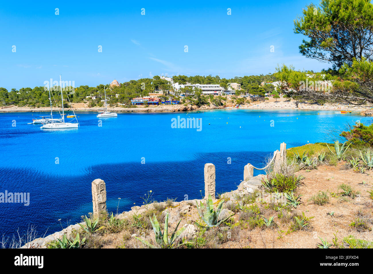 View of beautiful coast of Cala Portinatx bay with azure blue sea water ...