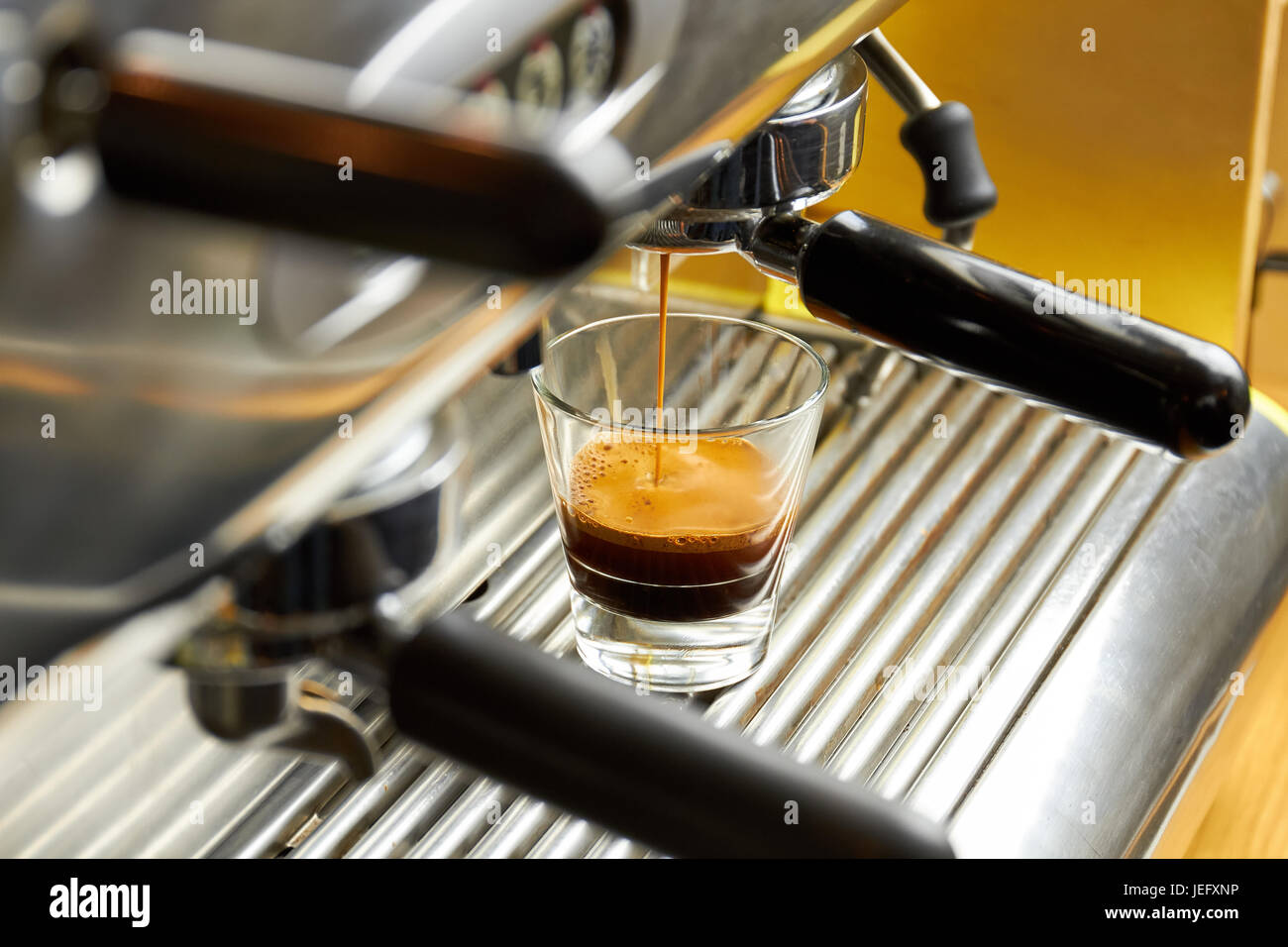 Coffee machine pouring espresso Stock Photo - Alamy
