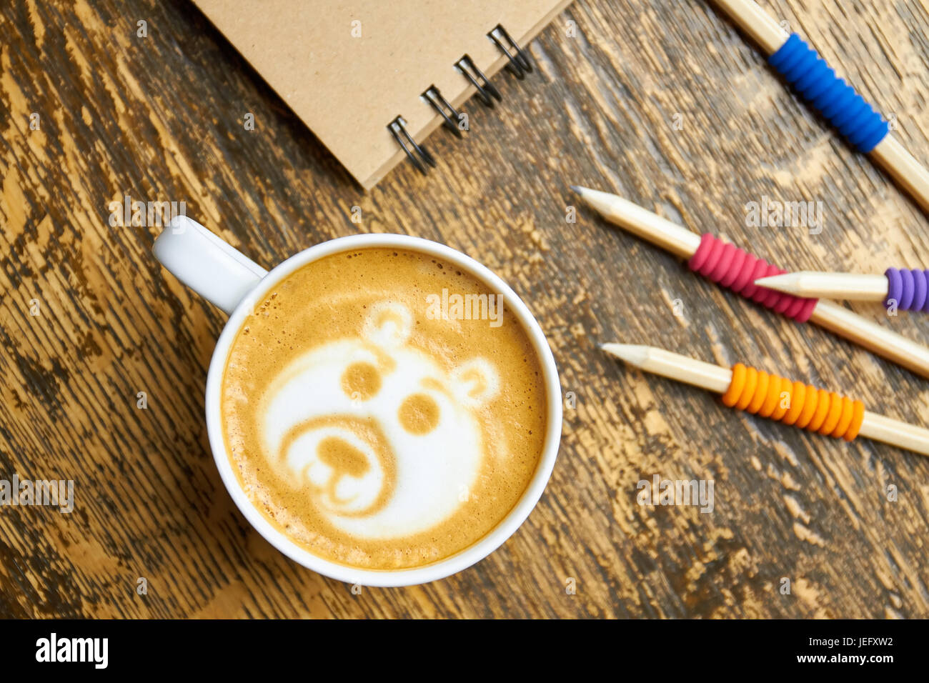 Coffee cup and pencils Stock Photo - Alamy