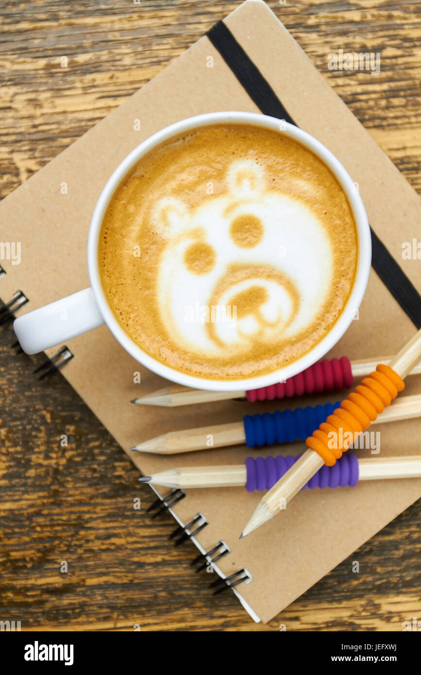 Coffee cup, pencils and notebook Stock Photo - Alamy
