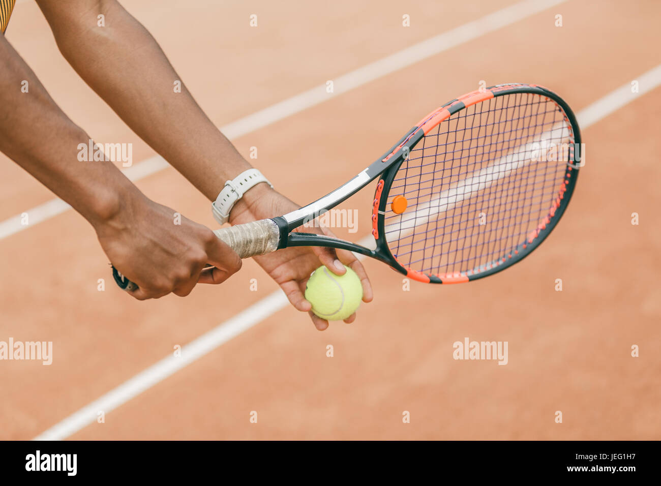 Close-up of male hand holding tennis ball and racket Stock Photo - Alamy