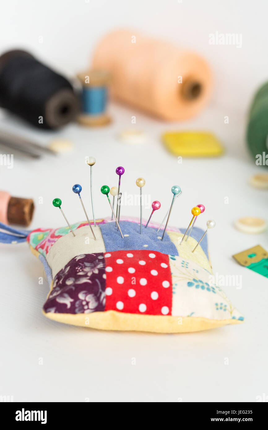 needlework, craft, sewing and tailoring concept - close-up on white ...