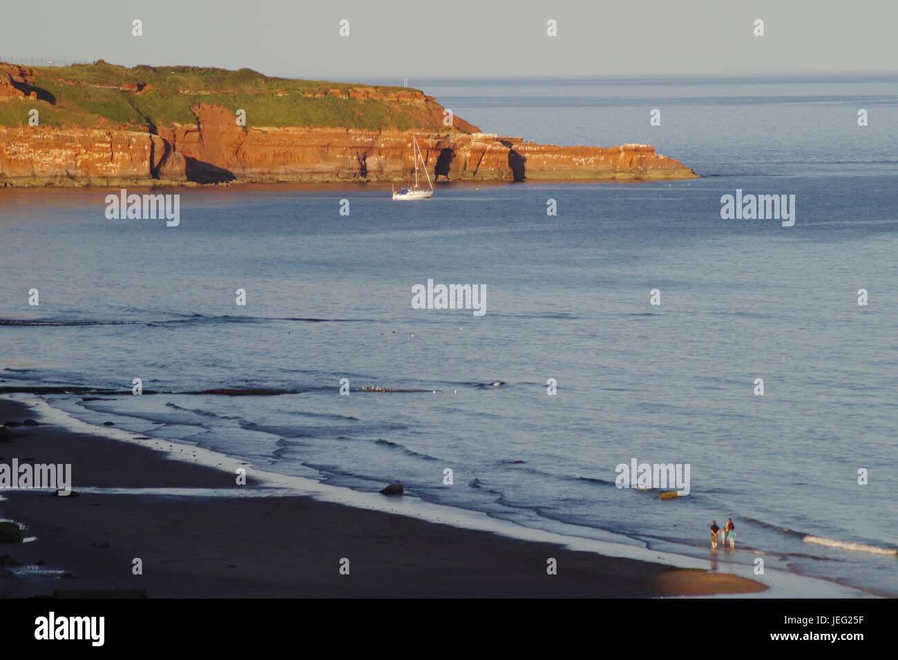 A Yacht Moored by the Red Sandstone Cliff of Straight Point at Sandy ...