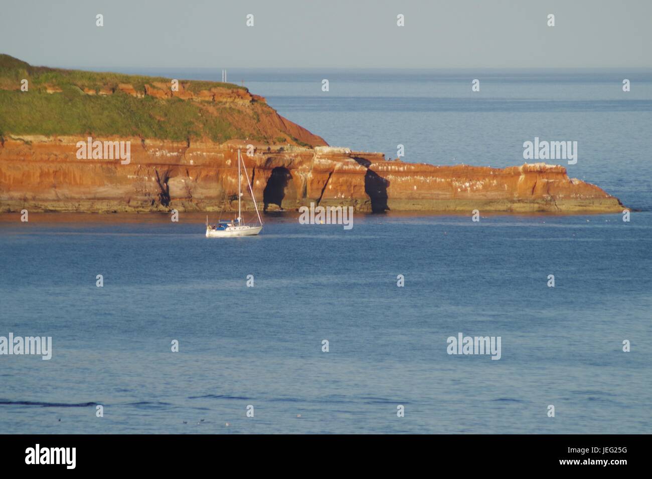 A Yacht Moored by the Red Sandstone Cliff of Straight Point at Sandy ...