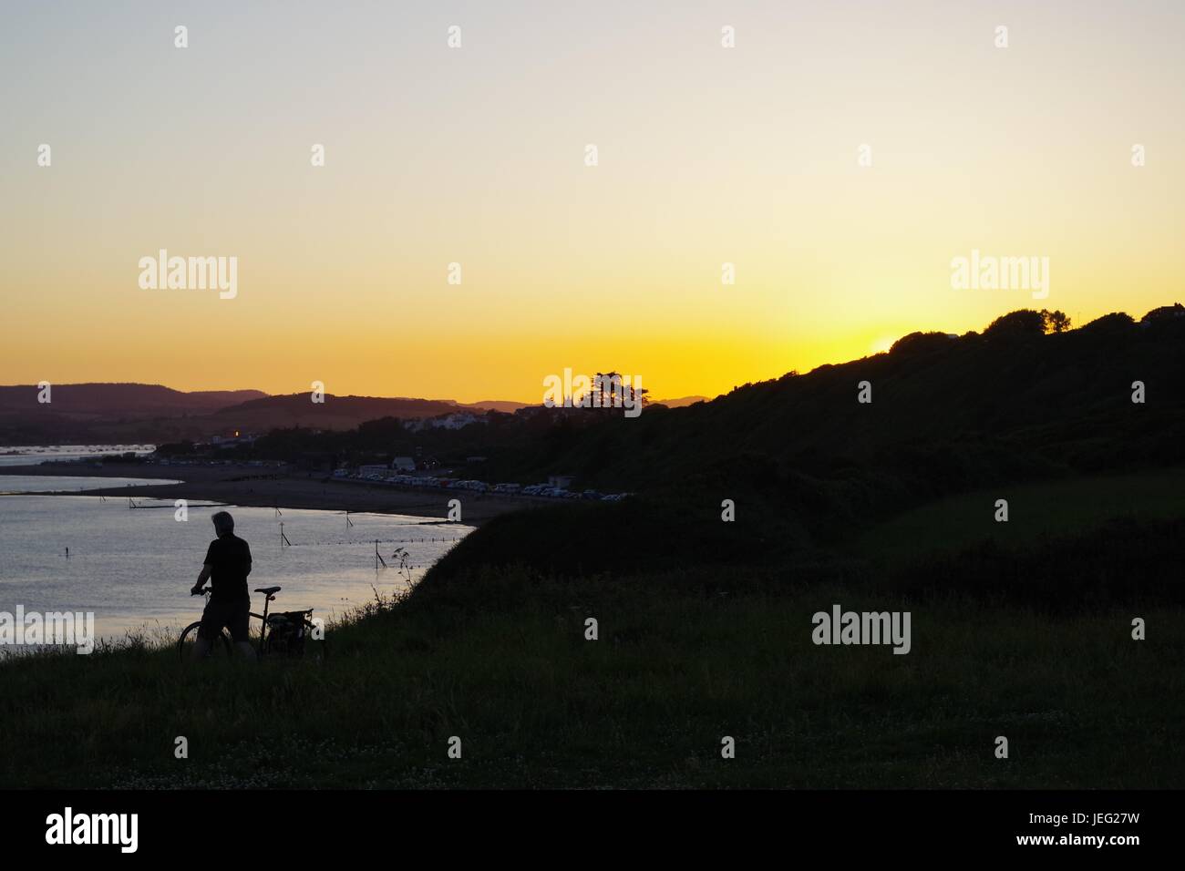 Cyclist Watches the Sunset, Orcombe Point, World Heritage Site ...